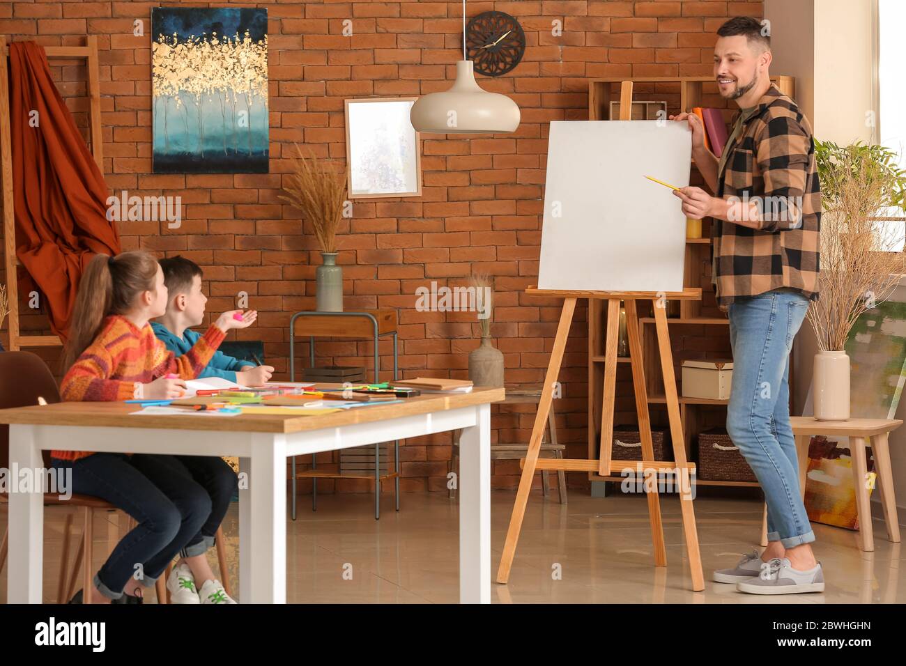 Drawing teacher giving optional classes at school Stock Photo - Alamy