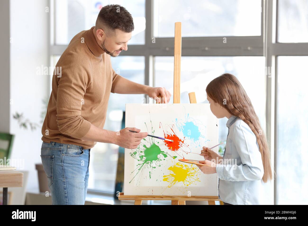 Drawing teacher giving optional classes at school Stock Photo - Alamy