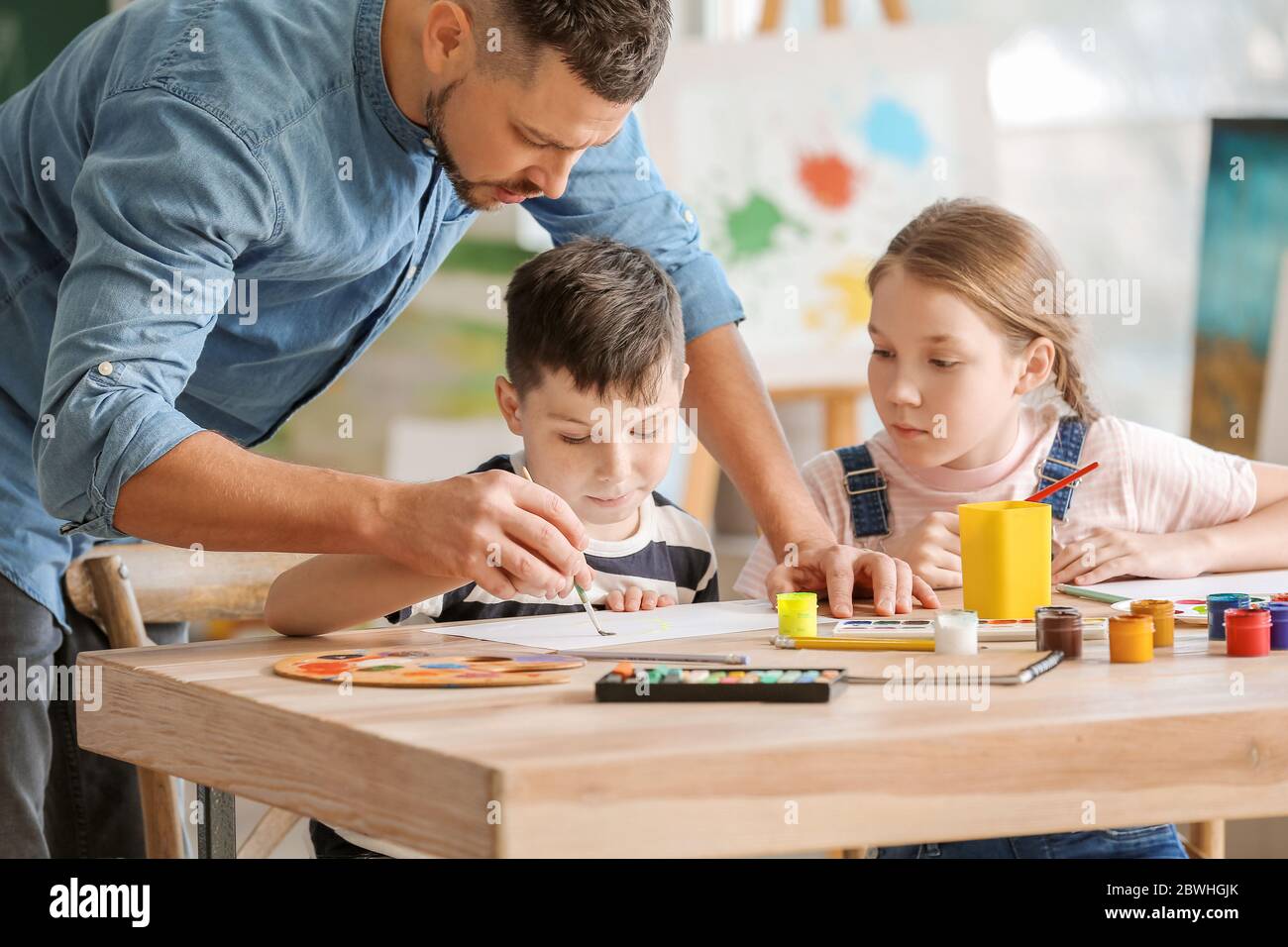 Drawing teacher giving optional classes at school Stock Photo - Alamy