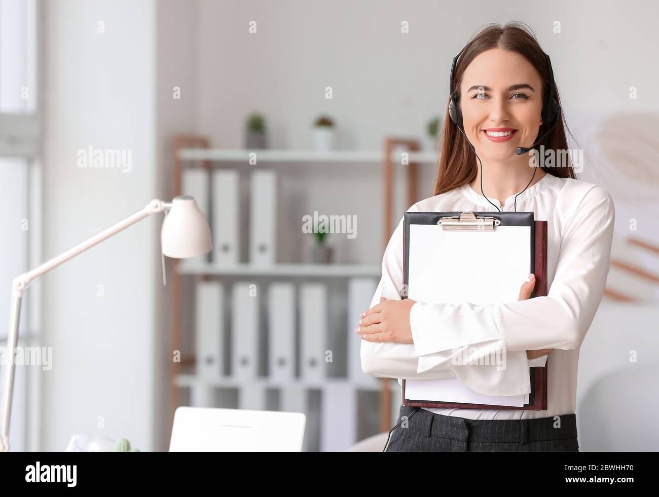 Beautiful young secretary in office Stock Photo - Alamy