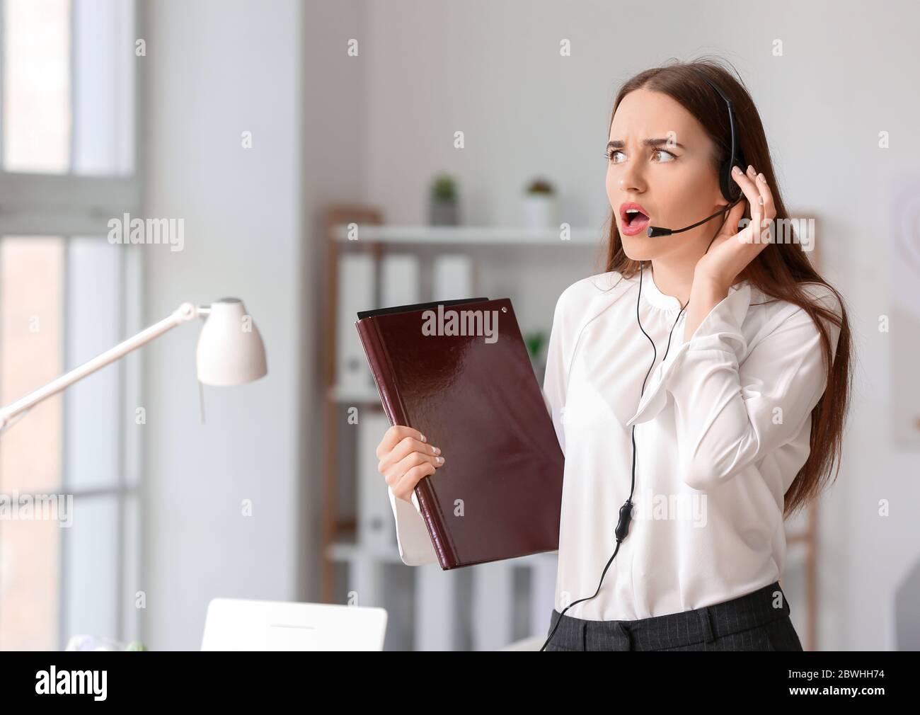 Stressed young secretary in office Stock Photo - Alamy