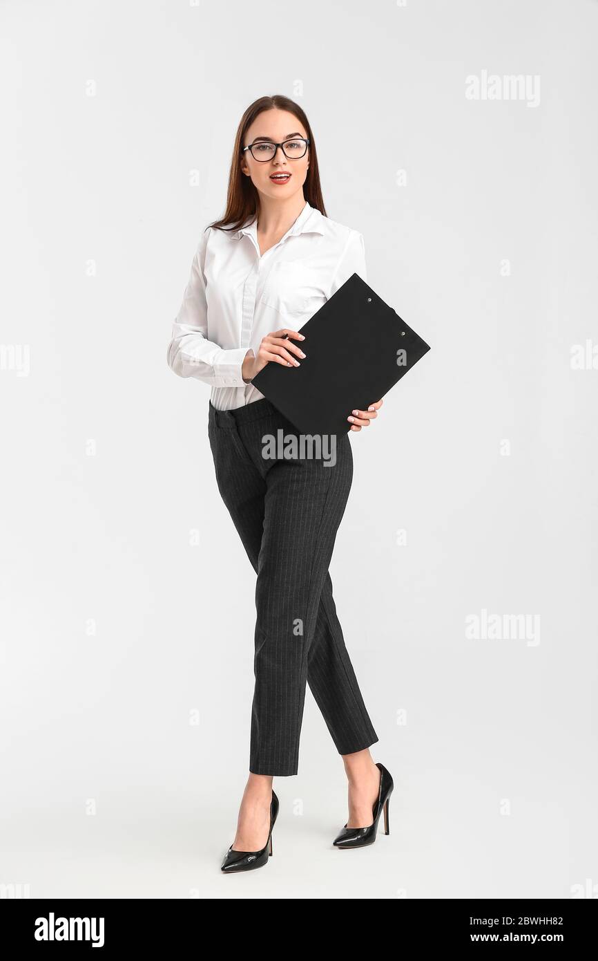 Beautiful young secretary on white background Stock Photo - Alamy