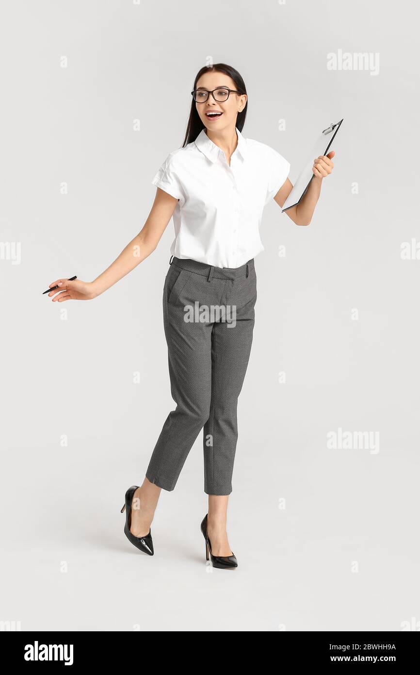 Beautiful young secretary on white background Stock Photo - Alamy