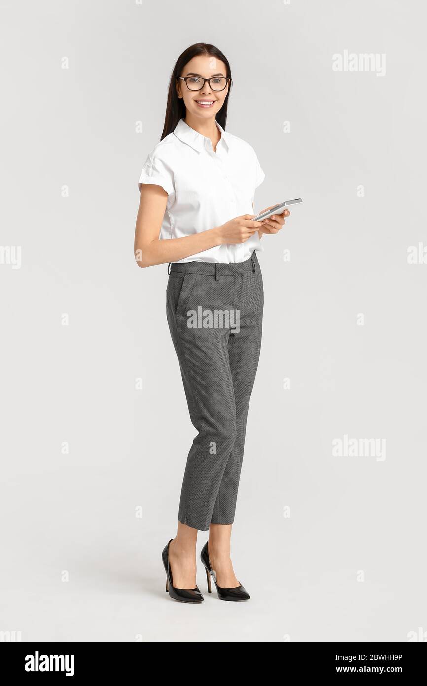 Beautiful young secretary on white background Stock Photo - Alamy