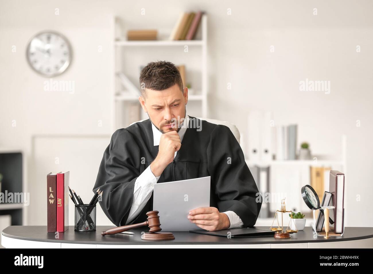 Male judge working at table in office Stock Photo - Alamy