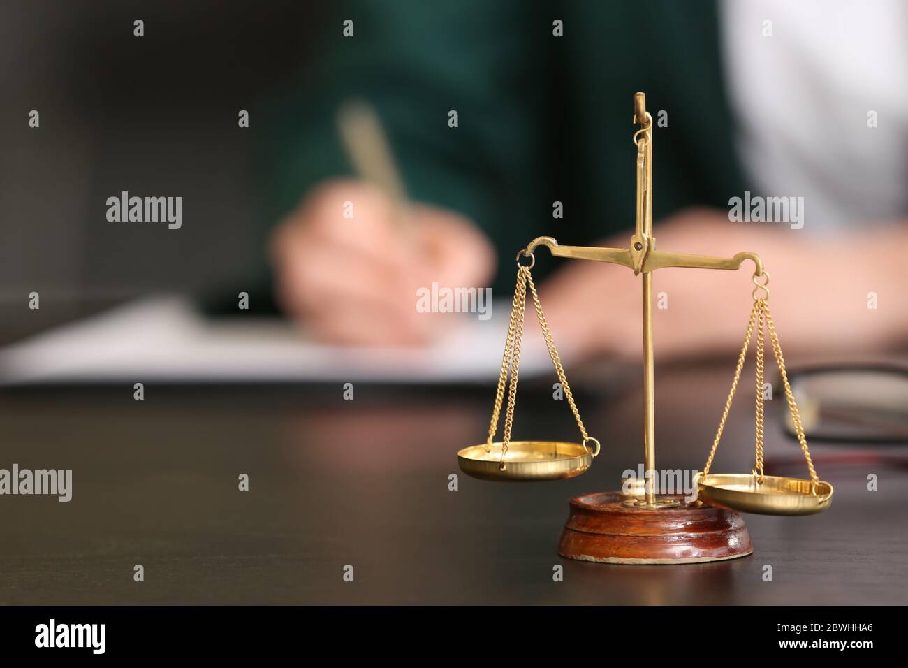 Scales of justice on table of female judge in courtroom, closeup Stock ...