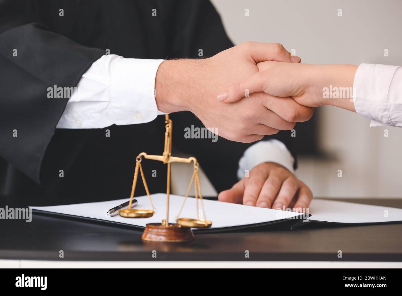 Male judge and client shaking hands in office, closeup Stock Photo - Alamy