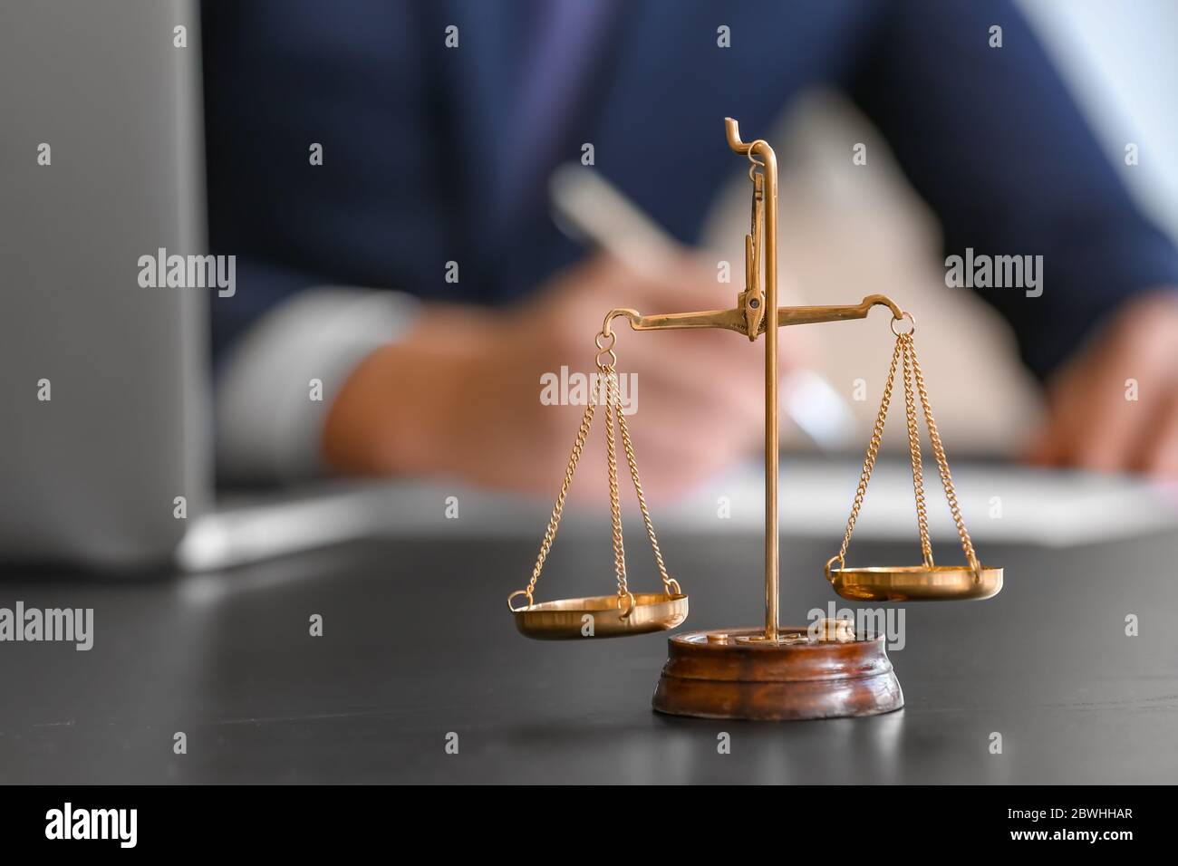 Scales of justice on table of male judge in courtroom, closeup Stock ...