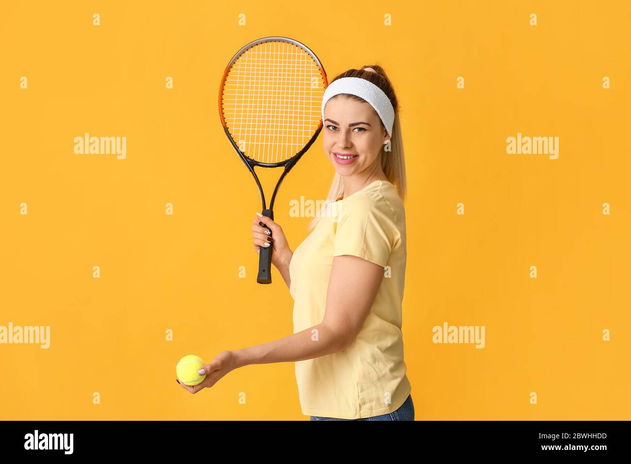 Portrait of beautiful tennis player on color background Stock Photo - Alamy