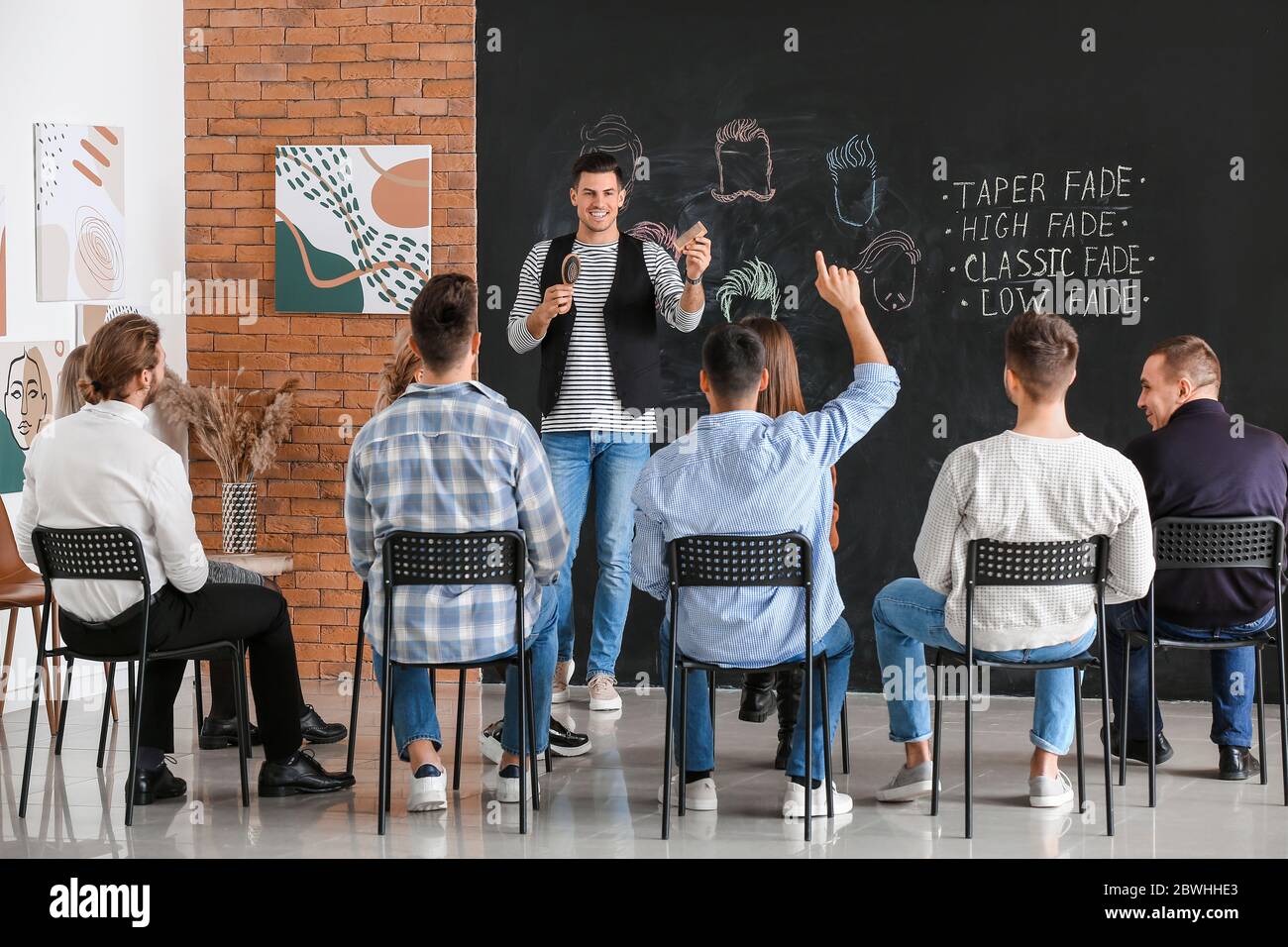 Professional hairdresser teaching young people in salon Stock Photo - Alamy