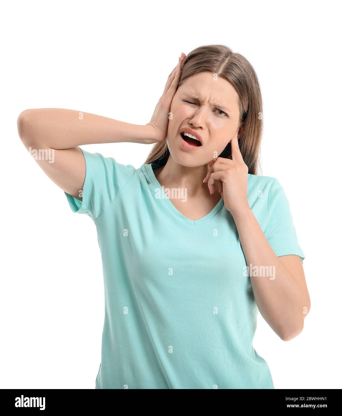 Young woman suffering from loud noise on white background Stock Photo ...