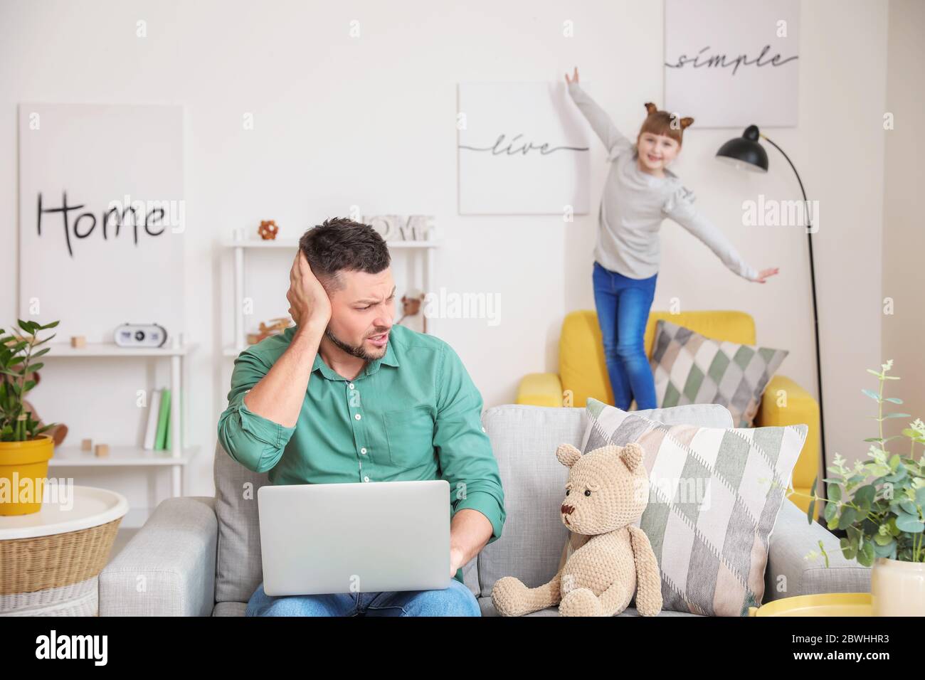 Little daughter keeping father from his work at home Stock Photo - Alamy