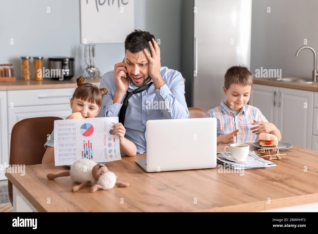 Little children keeping father from his work at home Stock Photo - Alamy