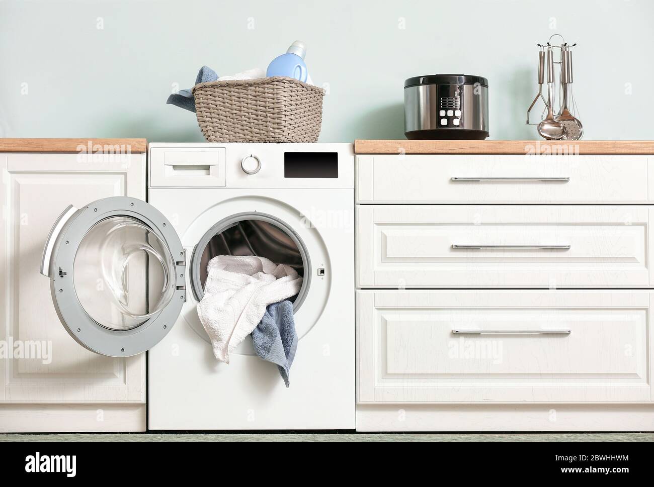 Interior of kitchen with modern washing machine Stock Photo - Alamy