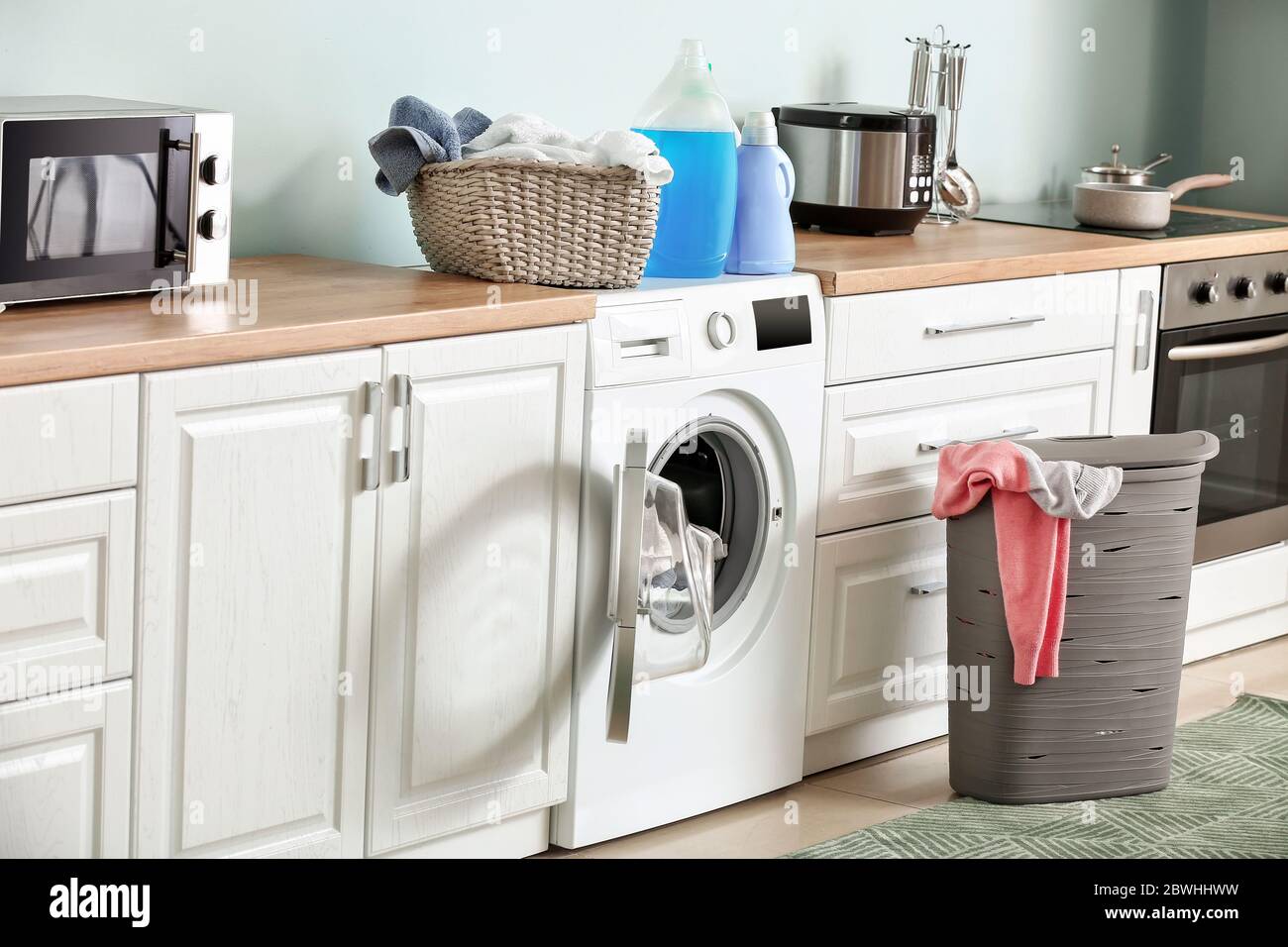 Interior of kitchen with modern washing machine Stock Photo - Alamy