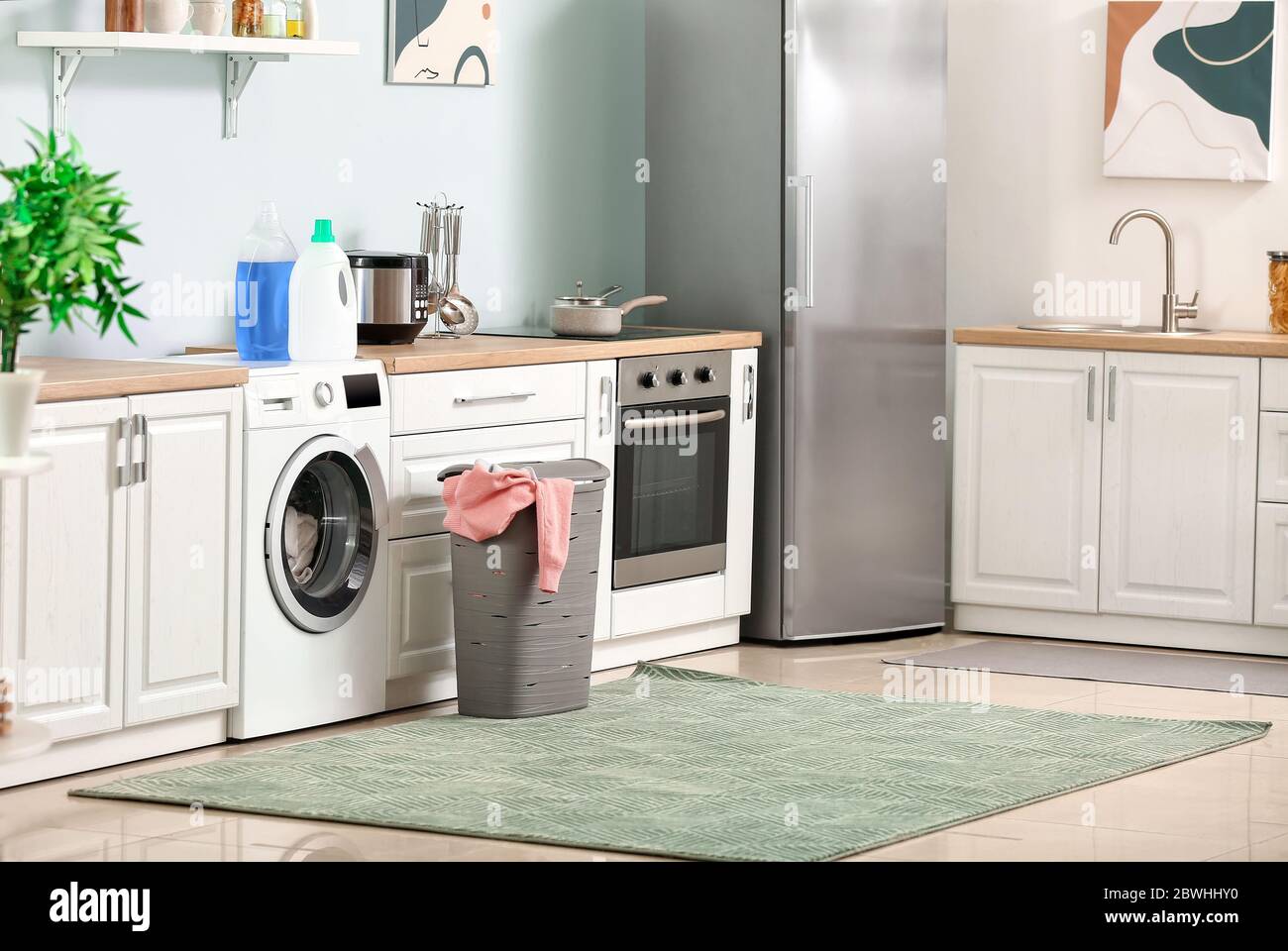 Interior of kitchen with modern washing machine Stock Photo - Alamy