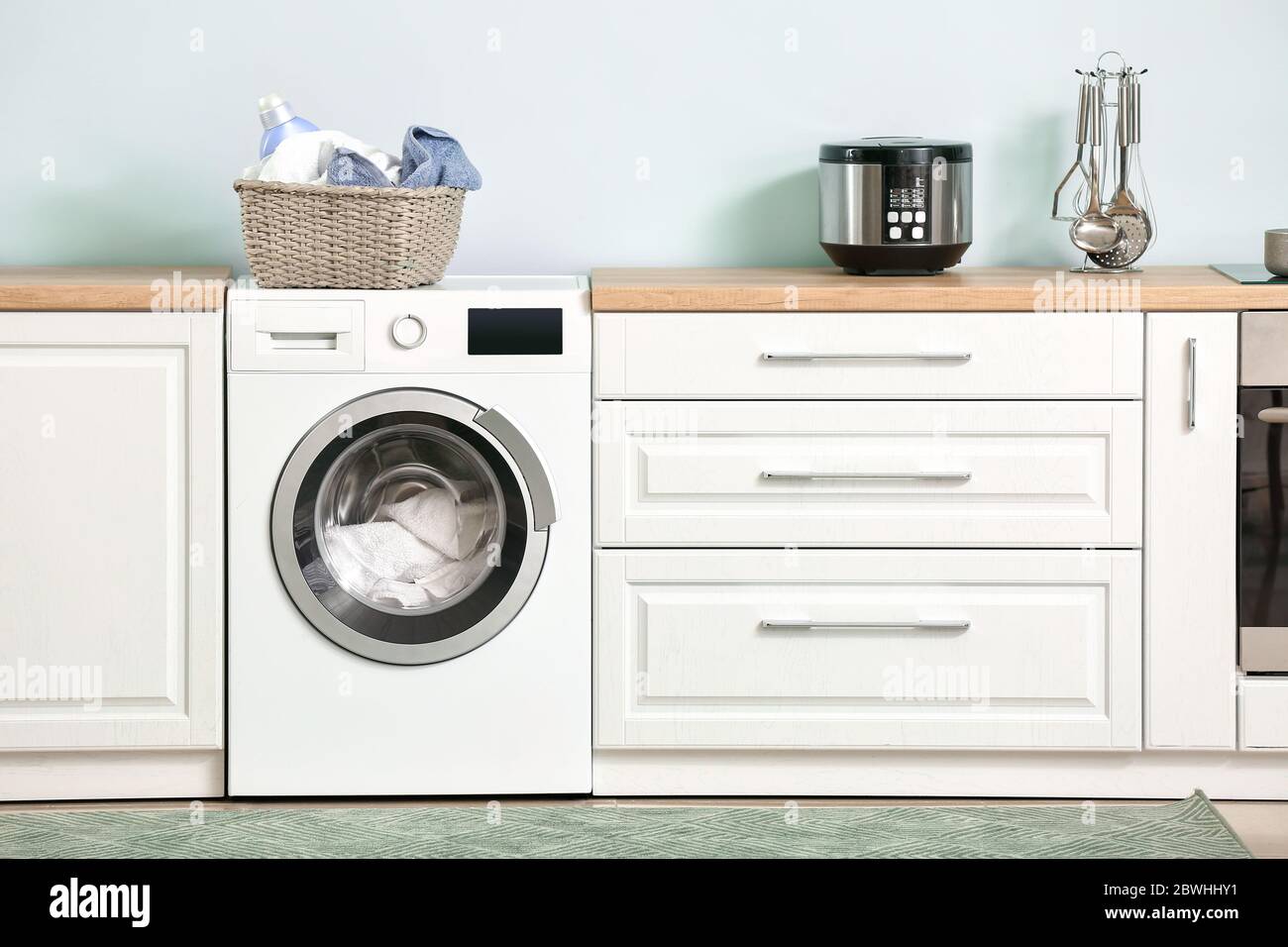 Interior of kitchen with modern washing machine Stock Photo - Alamy
