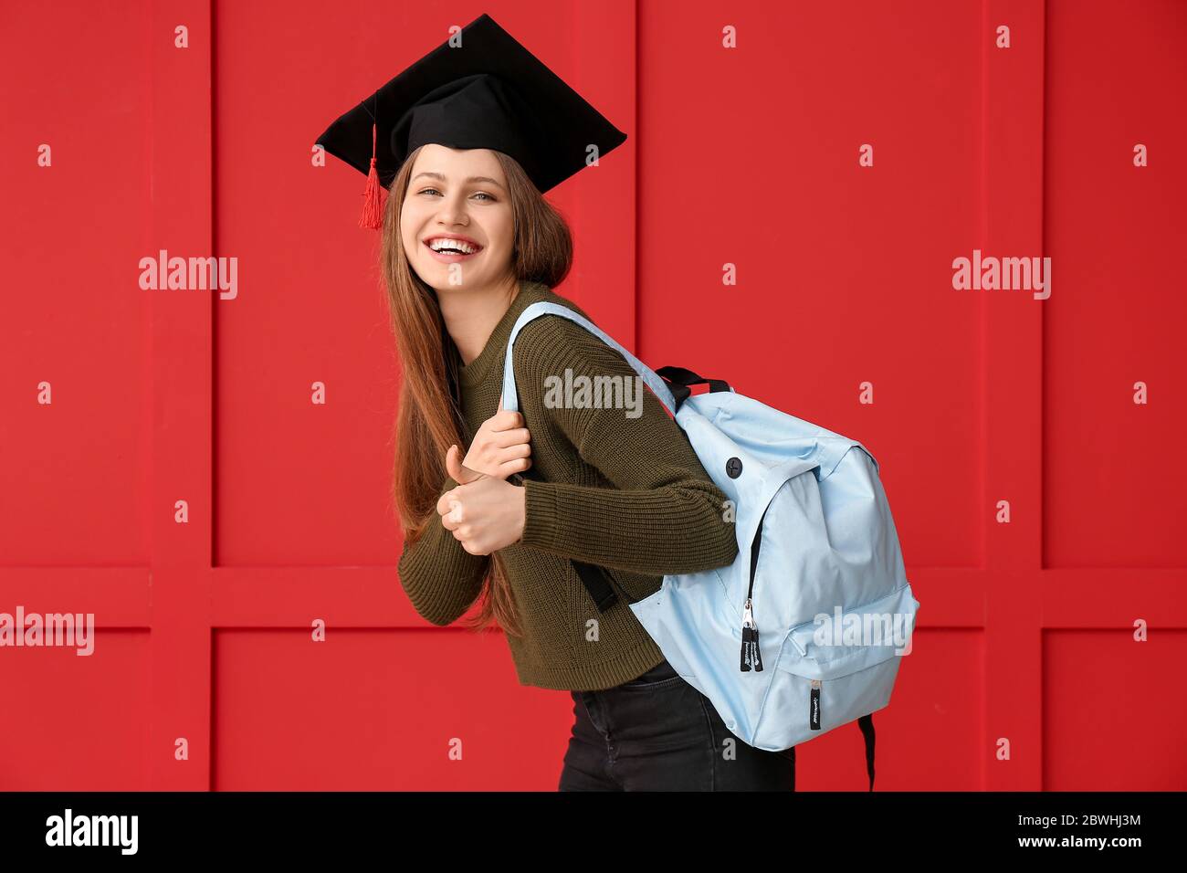 Female graduating student on color background Stock Photo - Alamy