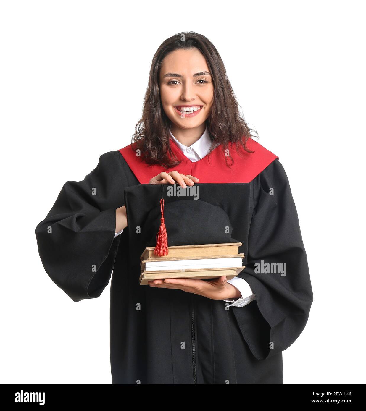 Female graduating student with books on white background Stock Photo ...