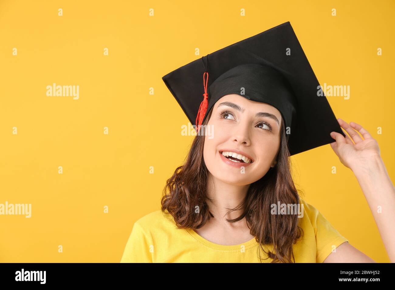 Female graduating student on color background Stock Photo - Alamy