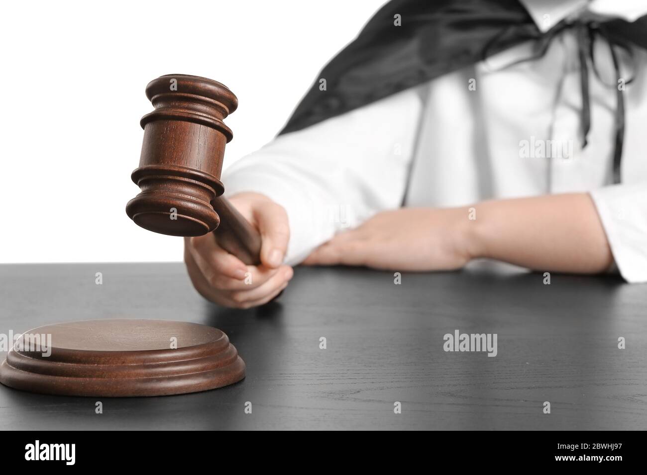 Little judge sitting at table against white background, closeup Stock ...