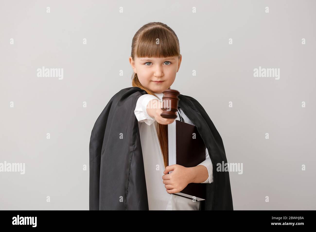 Portrait of little judge on grey background Stock Photo - Alamy