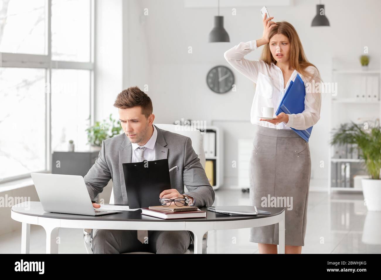 Angry boss and his worried secretary in office Stock Photo - Alamy