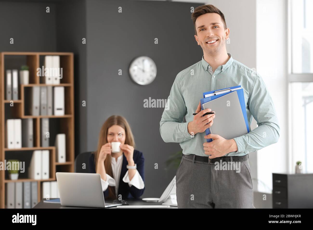 Male secretary and his beautiful boss in office Stock Photo - Alamy