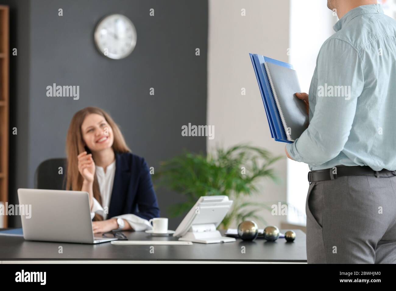 Male secretary and his beautiful boss in office Stock Photo - Alamy