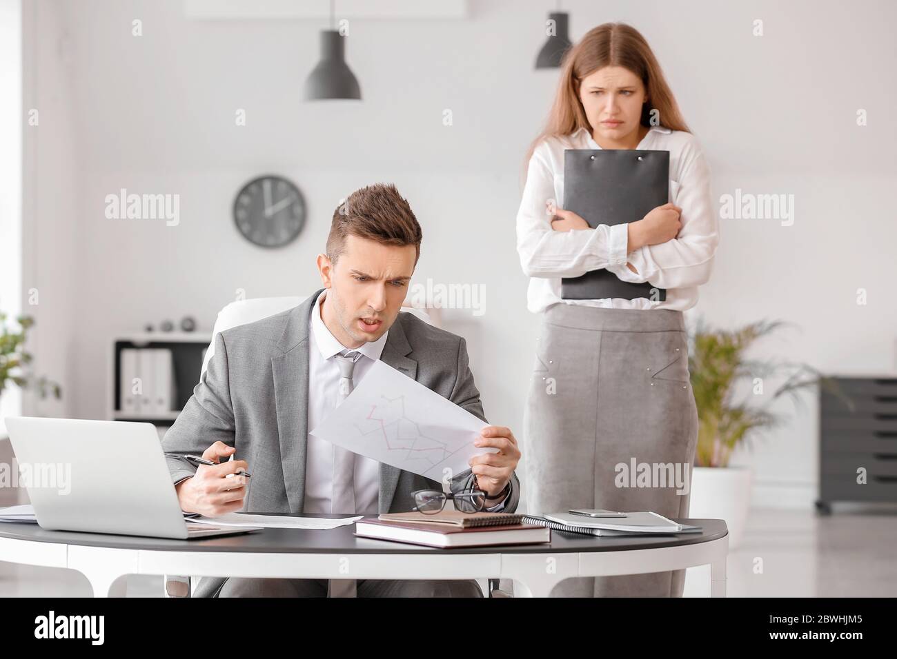 Angry boss and his worried secretary in office Stock Photo - Alamy