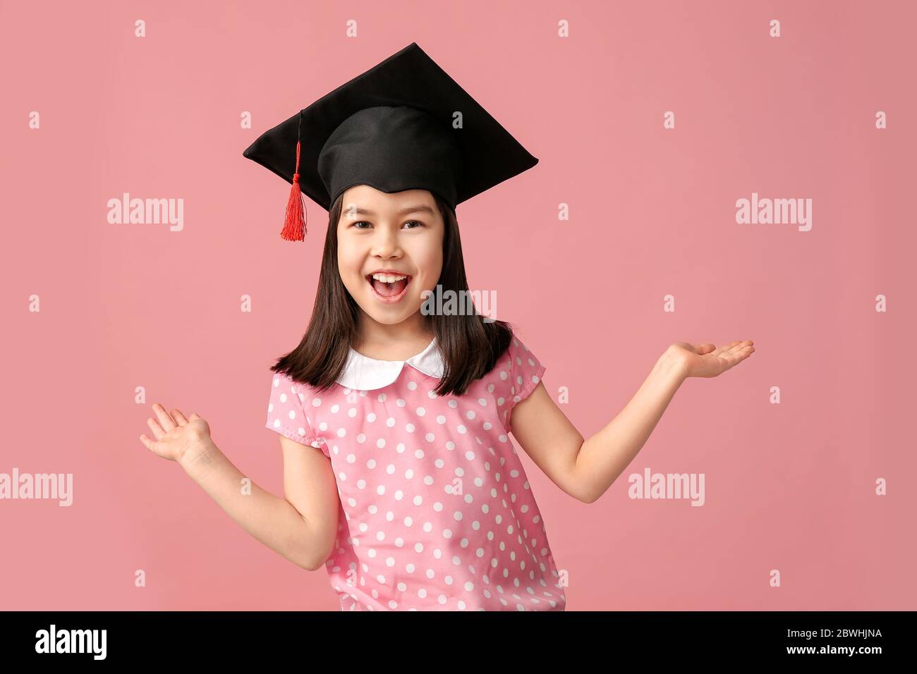 Little girl in graduation hat on color background Stock Photo - Alamy