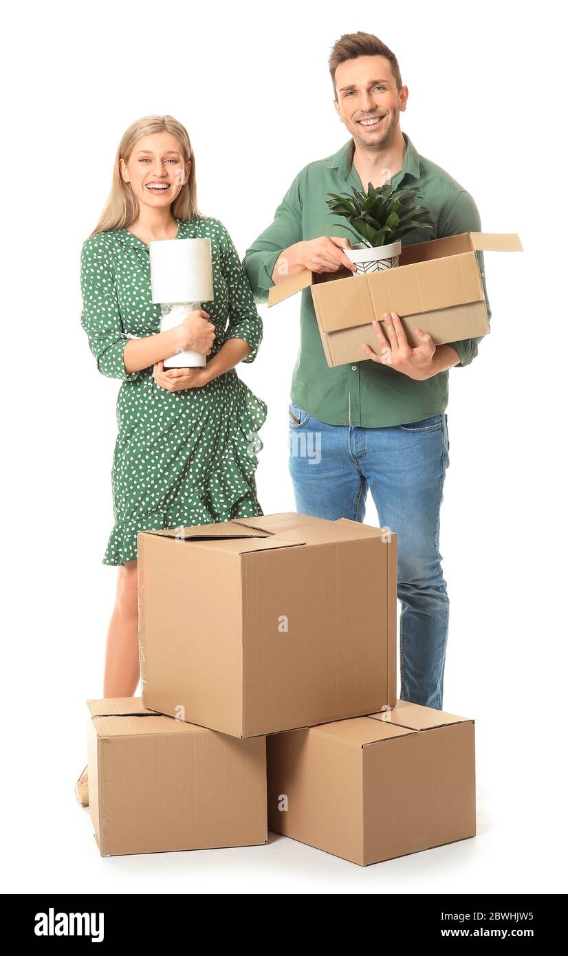 Young couple unpacking things on white background Stock Photo - Alamy