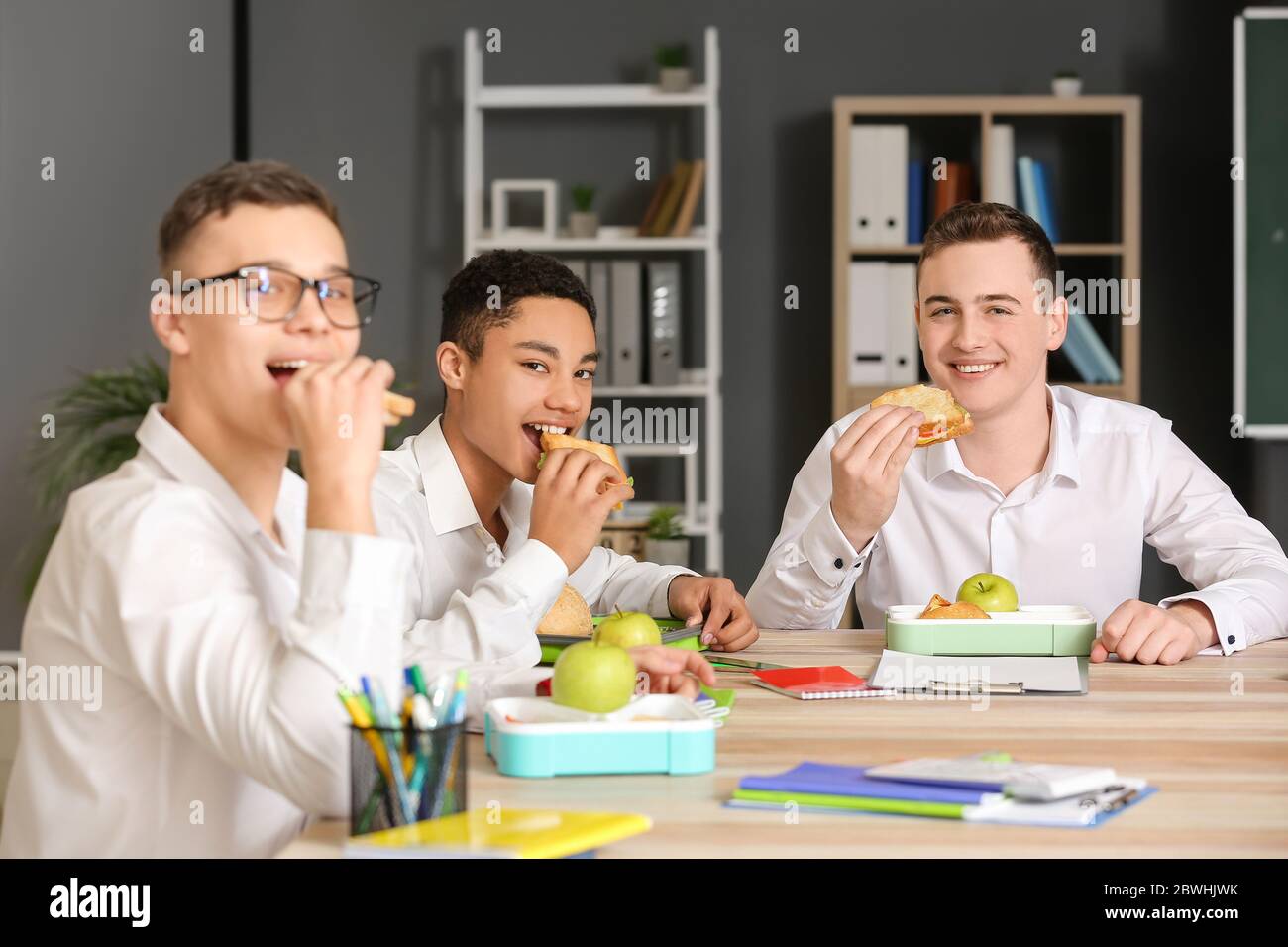 Pupils having lunch in classroom Stock Photo - Alamy