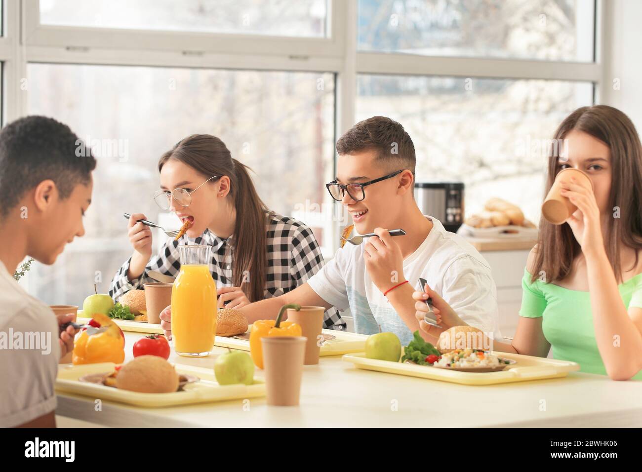 Pupils having lunch at school canteen Stock Photo - Alamy