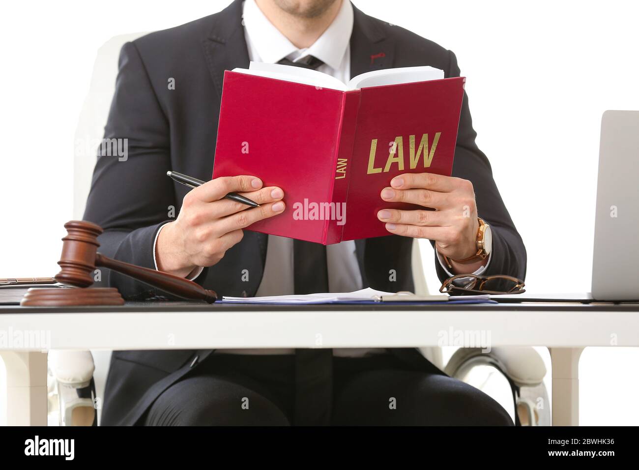 Male lawyer reading book in office Stock Photo - Alamy