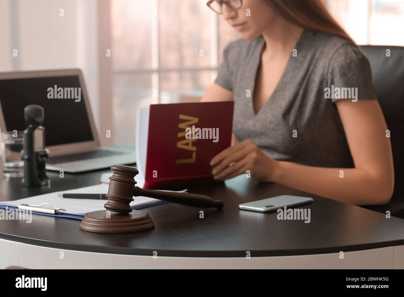 Female lawyer working in office Stock Photo - Alamy