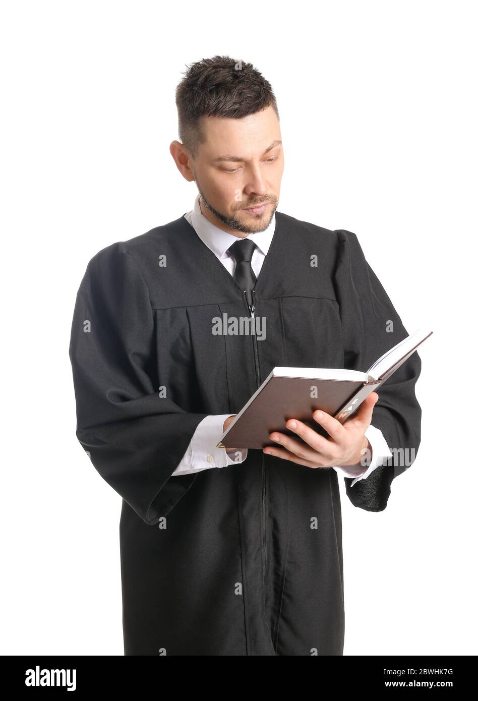 Male judge with book on white background Stock Photo - Alamy