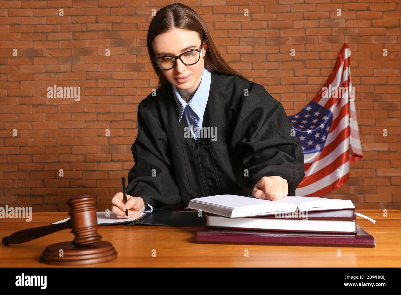 Female judge at table in courtroom Stock Photo - Alamy