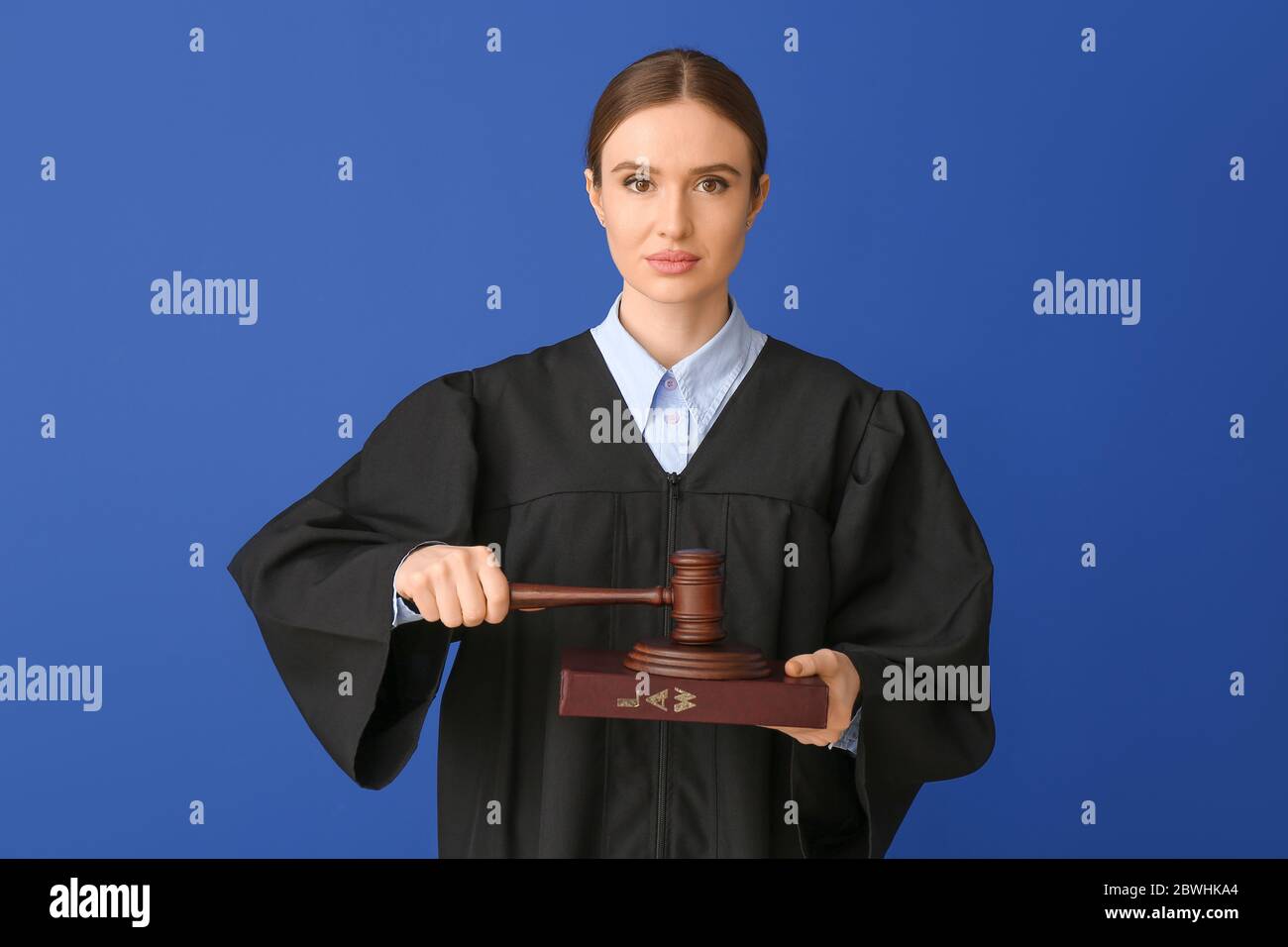 Female judge with gavel on color background Stock Photo - Alamy