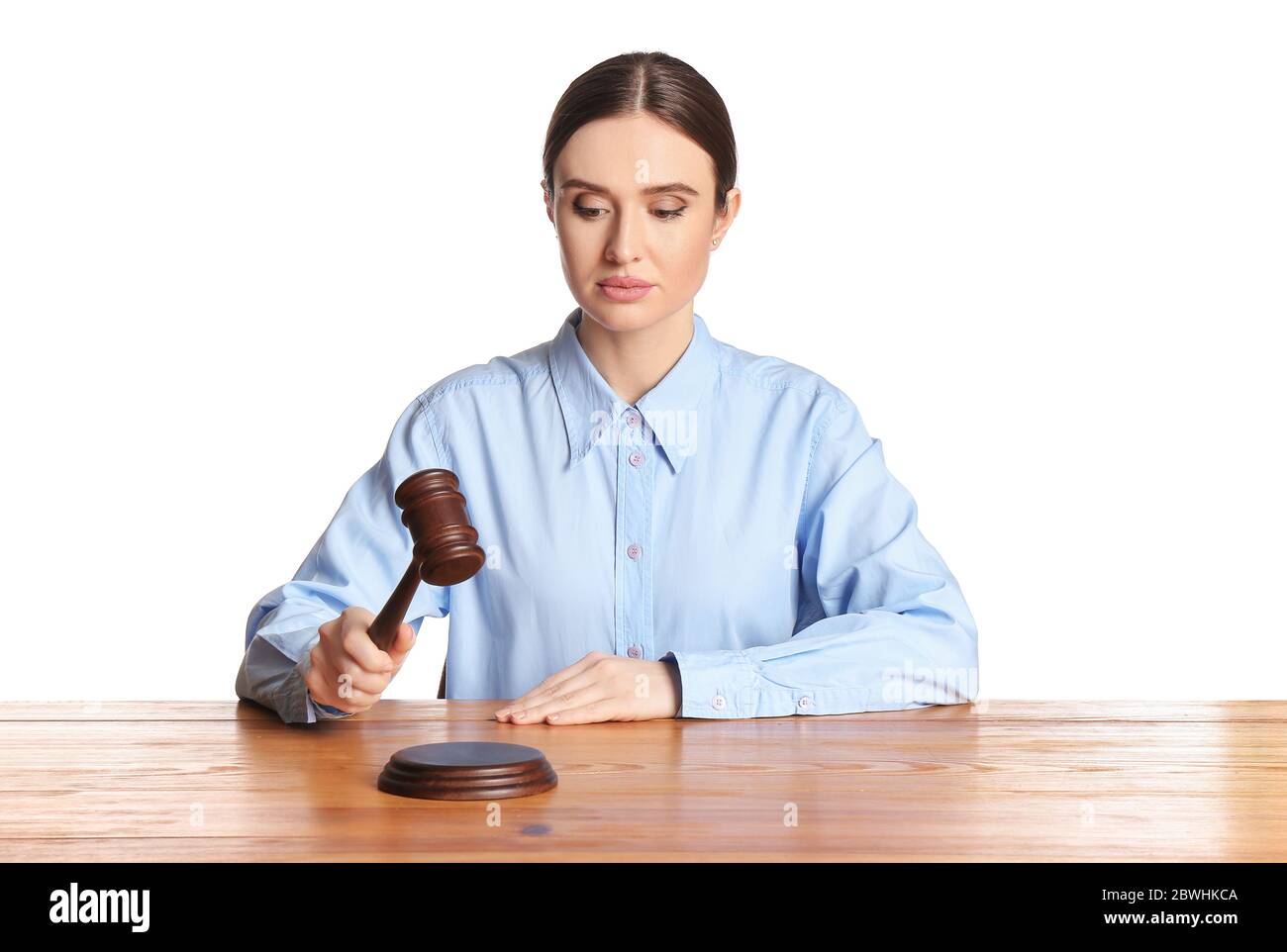 Female judge at table on white background Stock Photo - Alamy