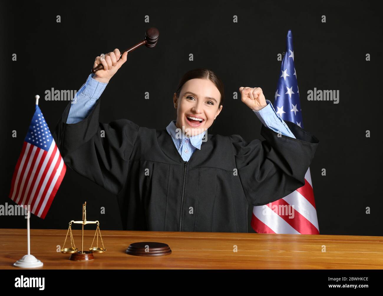 Happy female judge at table in courtroom Stock Photo - Alamy