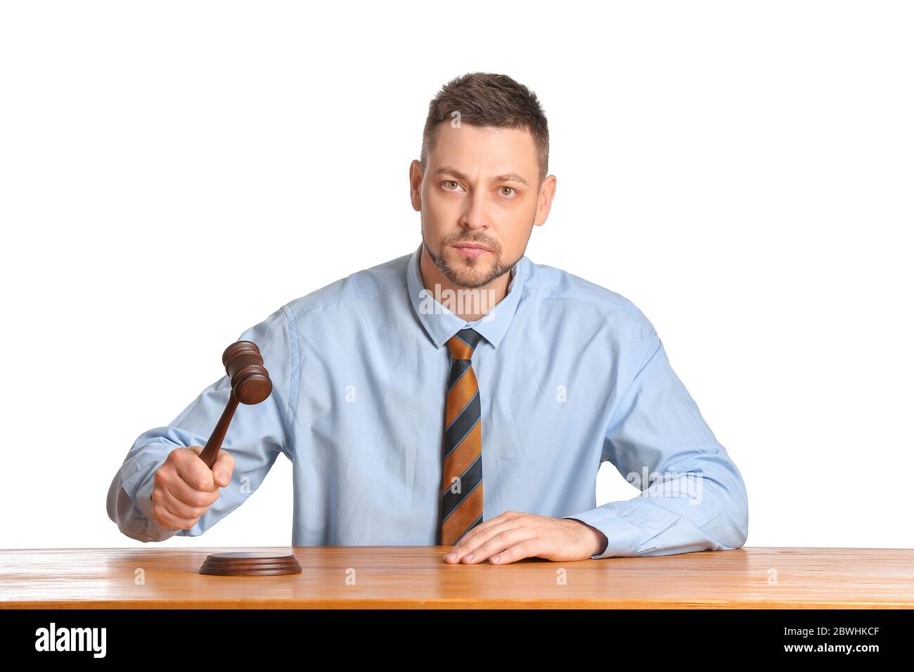 Male judge at table on white background Stock Photo - Alamy