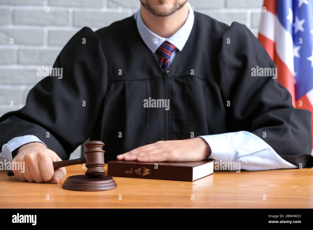 Male judge at table in courtroom Stock Photo - Alamy
