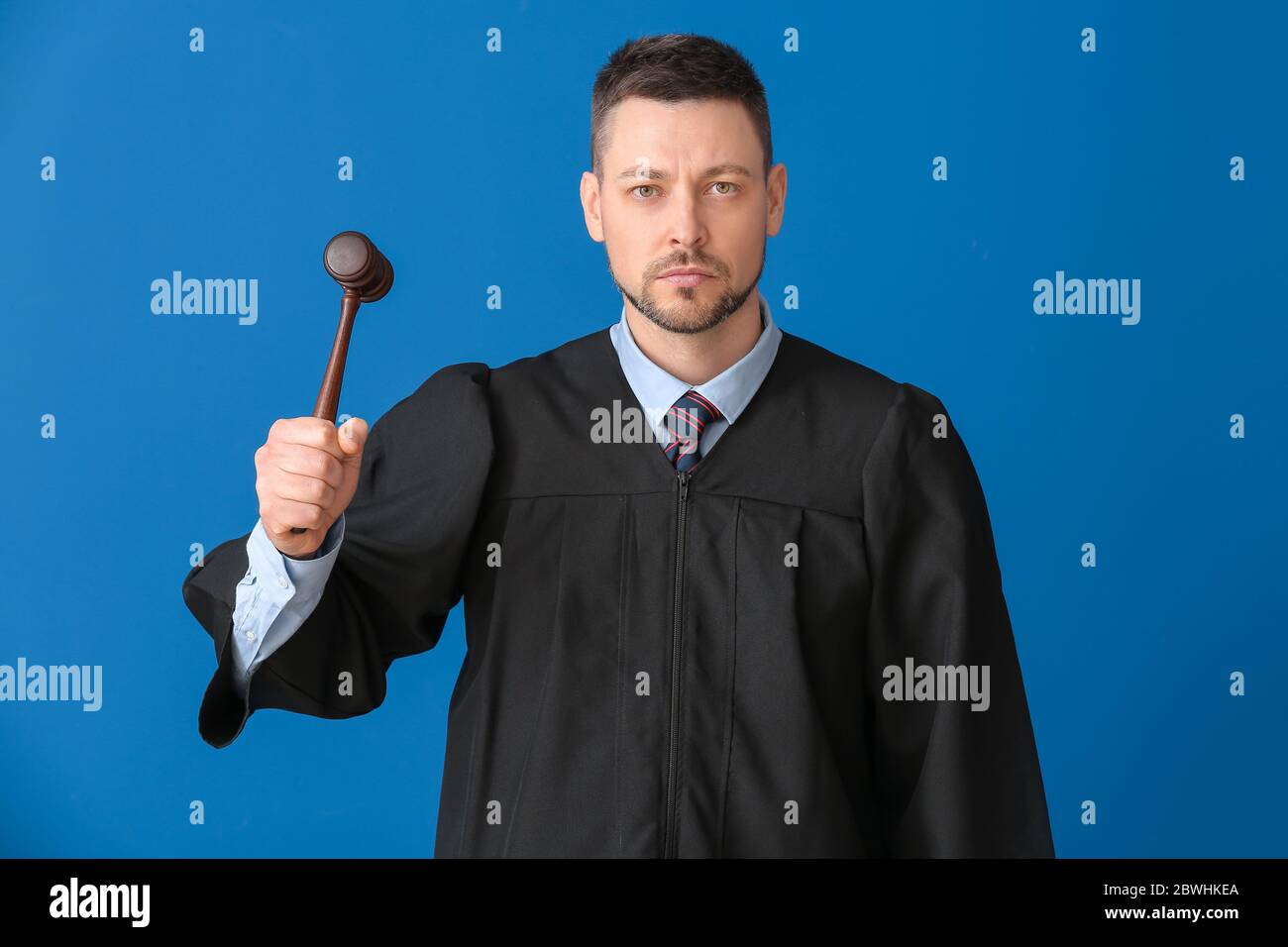 Strict male judge on color background Stock Photo - Alamy