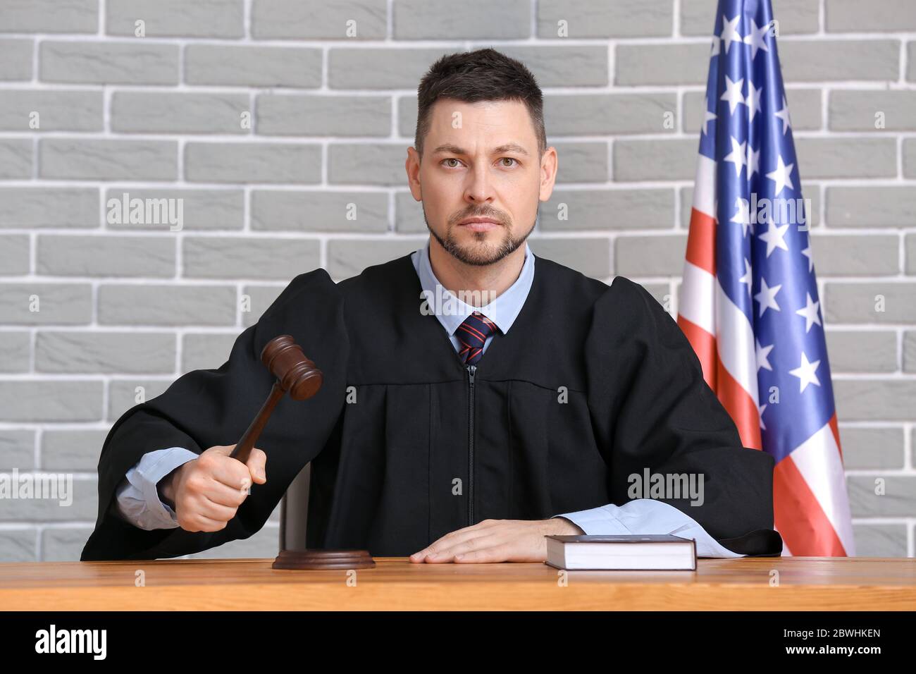 Male judge at table in courtroom Stock Photo - Alamy