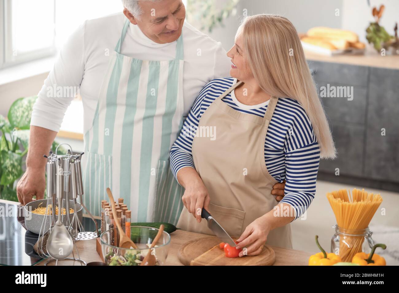Caucasian elderly couple cooking romantic hi-res stock photography and ...