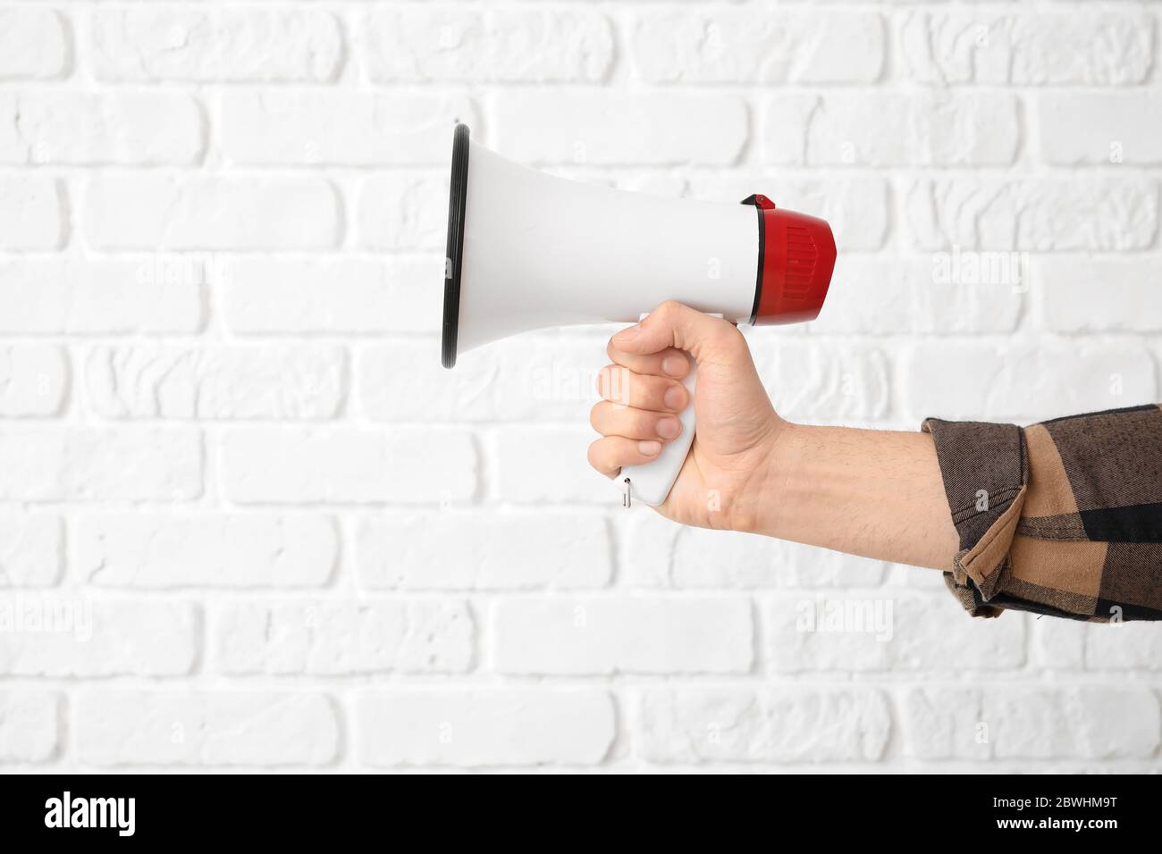 Male hand with megaphone on white background Stock Photo - Alamy