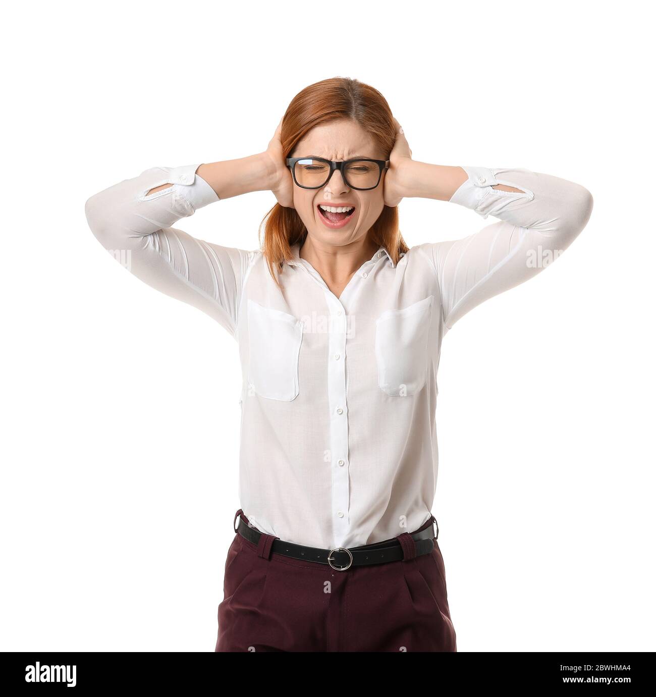 Young woman suffering from loud noise on white background Stock Photo ...