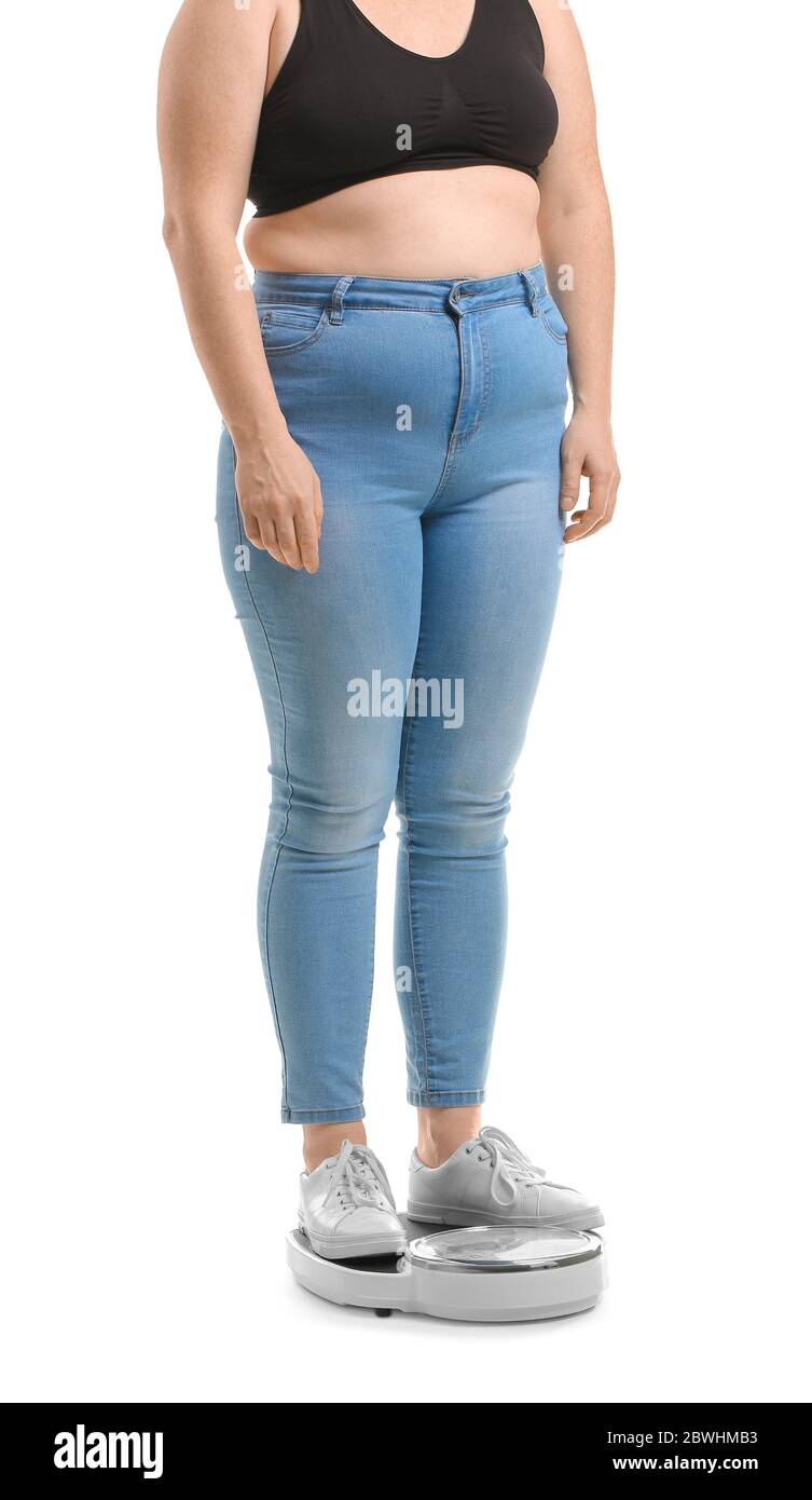 Overweight woman with scales on white background. Weight loss concept ...