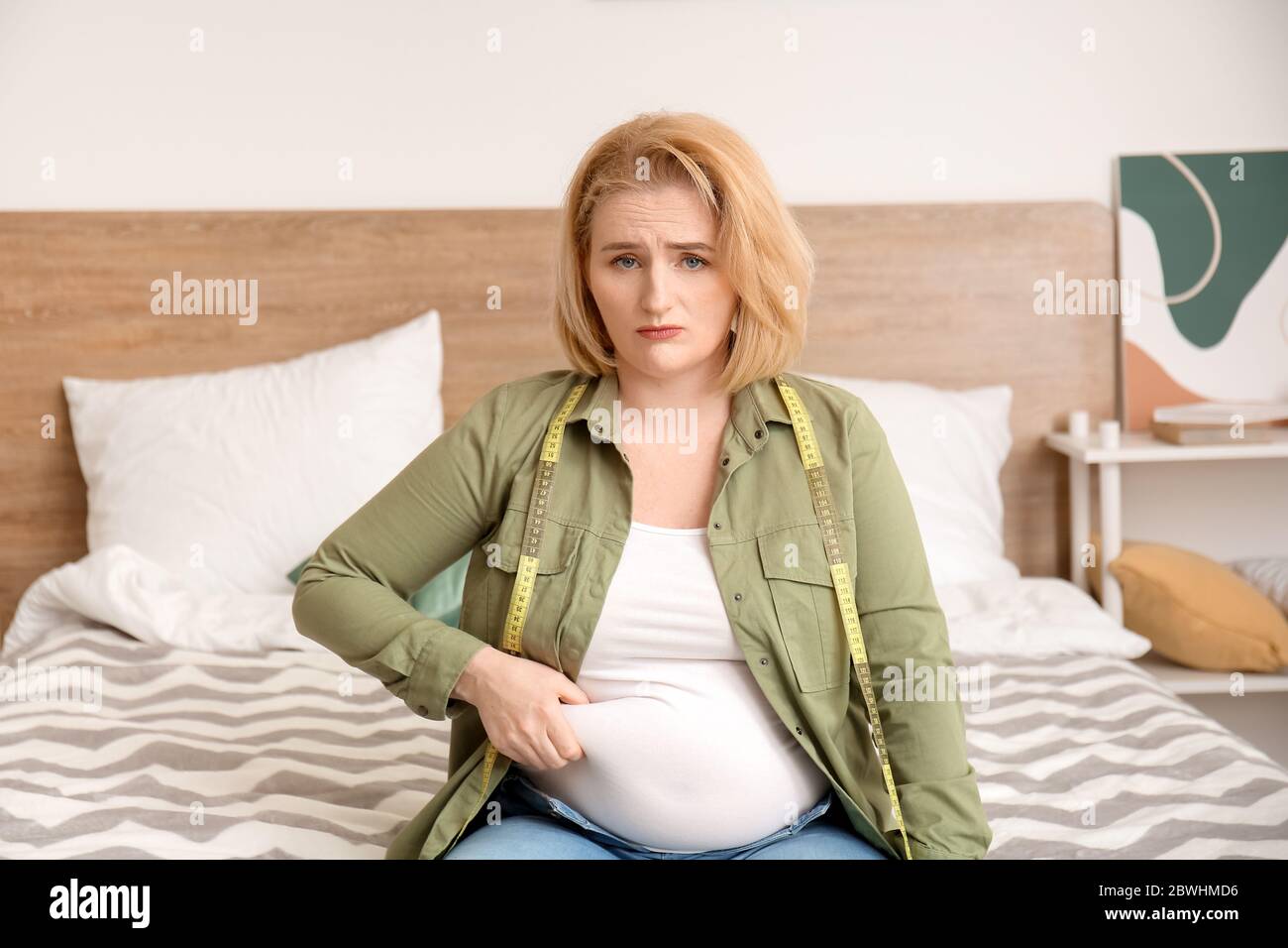 Sad overweight woman at home. Weight loss concept Stock Photo - Alamy